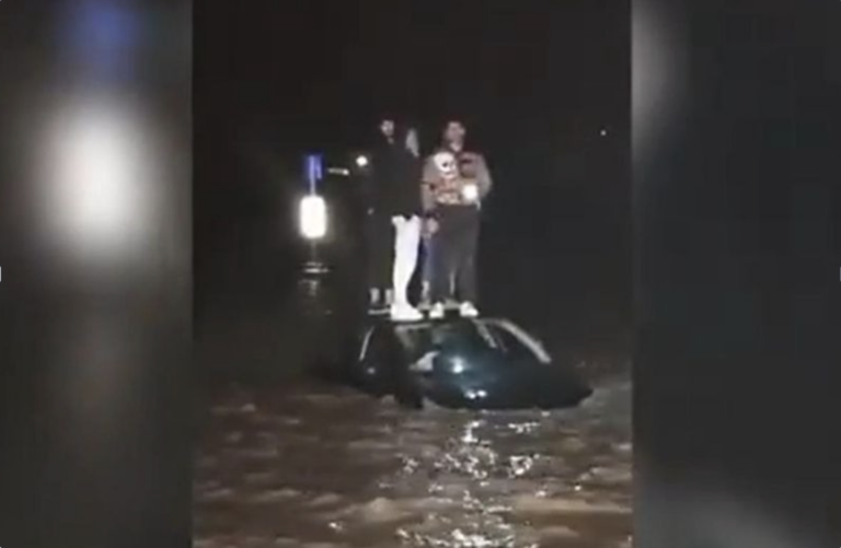 WATCH: Tragedy avoided as four young men rescued from roof of sinking ...