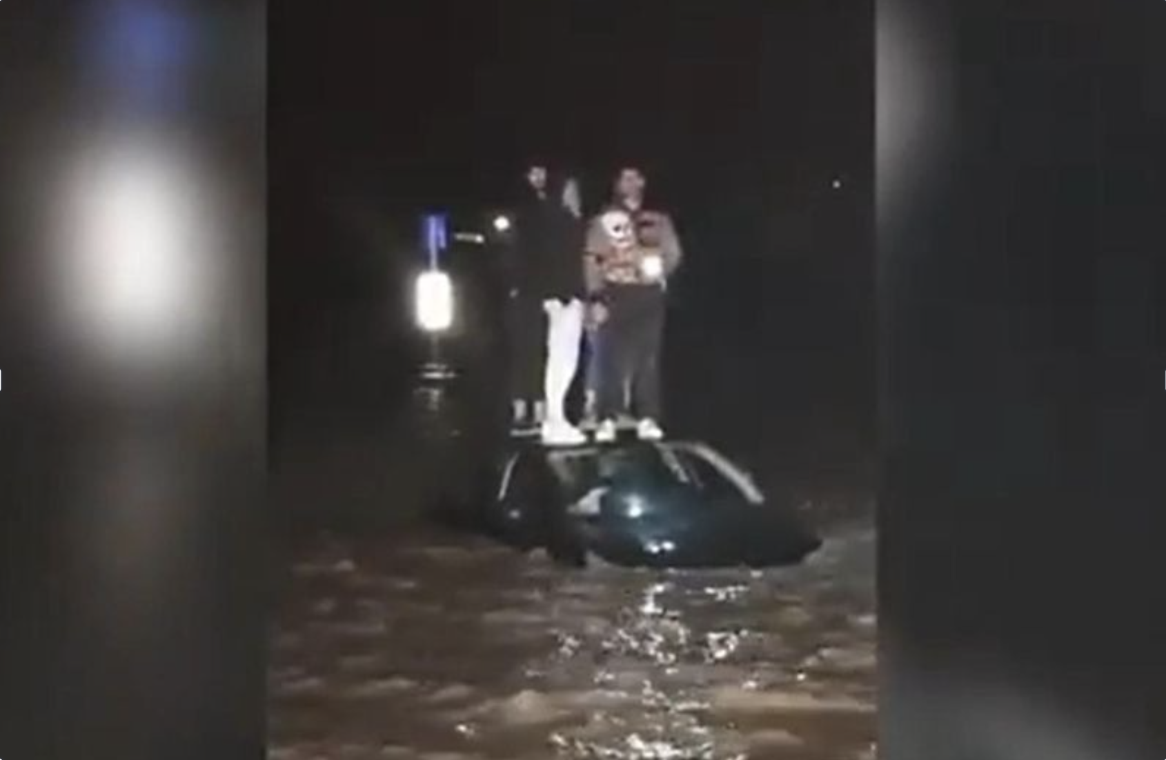 WATCH: Tragedy avoided as four young men rescued from roof of sinking ...